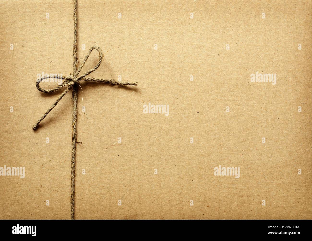 Brown cardboard box tied with rope Stock Photo - Alamy