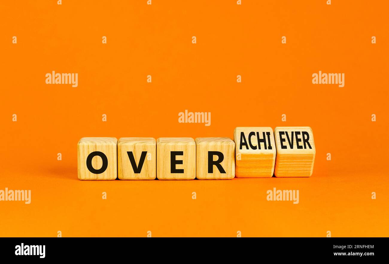 Achiever or overachiever symbol. Businessman turns wooden cubes and ...