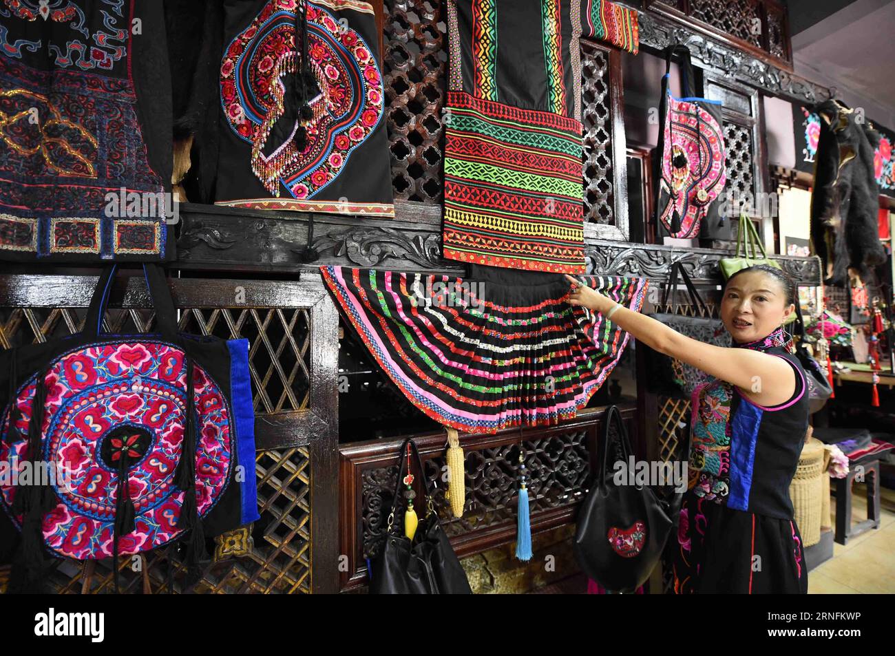 DAYAO, Aug. 14, 2016 -- Luo Jun introduces the embroidery products in ...