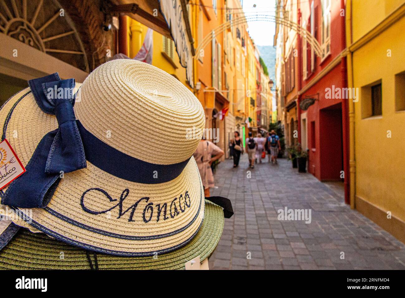 Crowds of tourists amongst he beautiful colourful houses of Monaco old ...