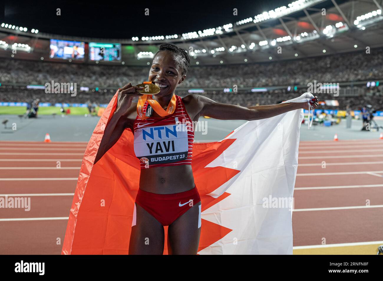 Winfred Mutile YAVI celebrating her victory with her country's flag in ...