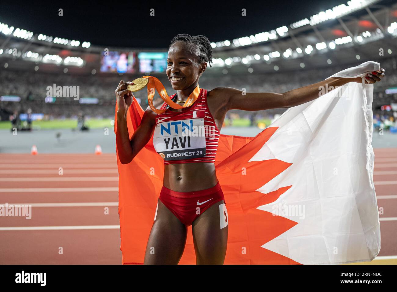 Winfred Mutile YAVI celebrating her victory with her country's flag in ...