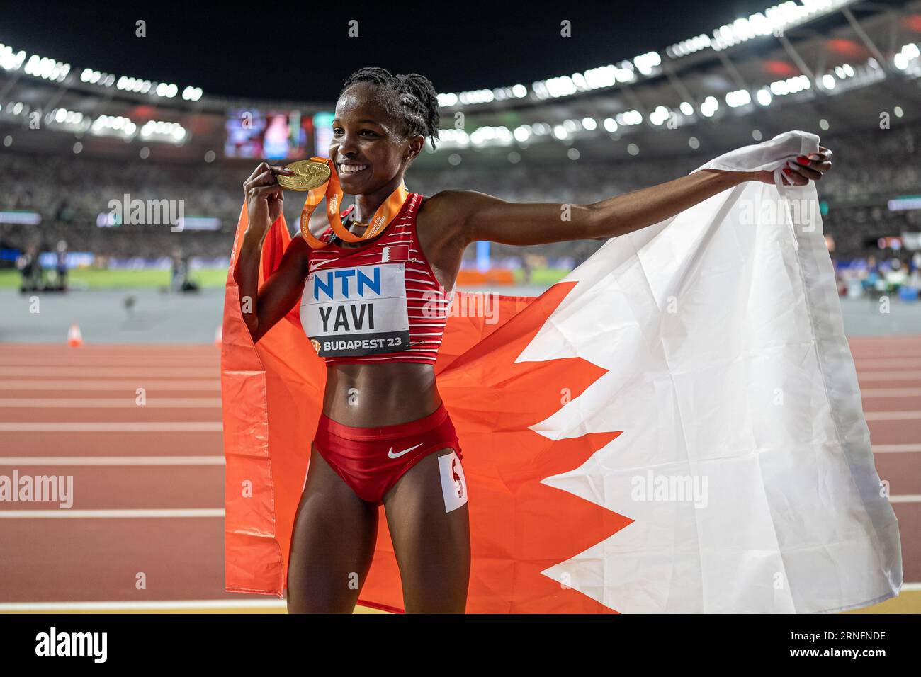 Winfred Mutile YAVI celebrating her victory with her country's flag in ...