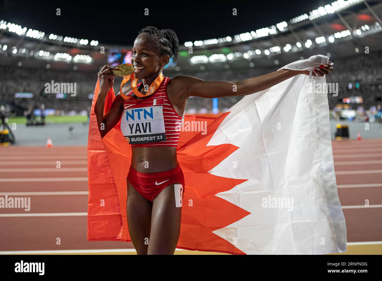 Winfred Mutile YAVI celebrating her victory with her country's flag in ...