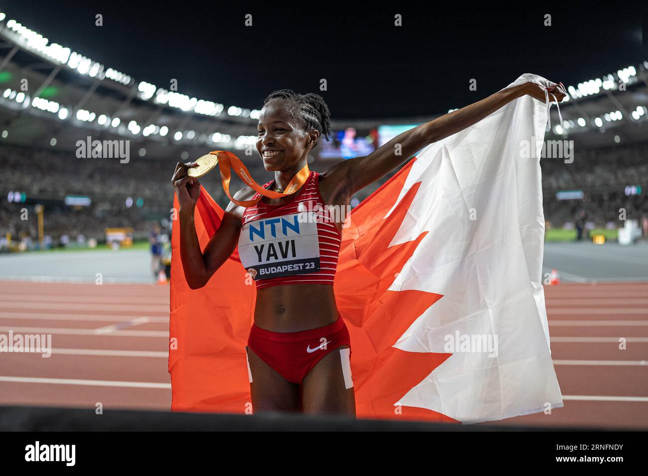 Winfred Mutile YAVI celebrating her victory with her country's flag in ...