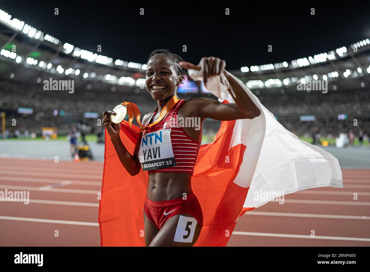 Winfred Mutile YAVI celebrating her victory with her country's flag in ...