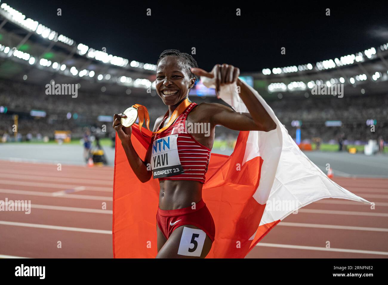 Winfred Mutile YAVI celebrating her victory with her country's flag in ...