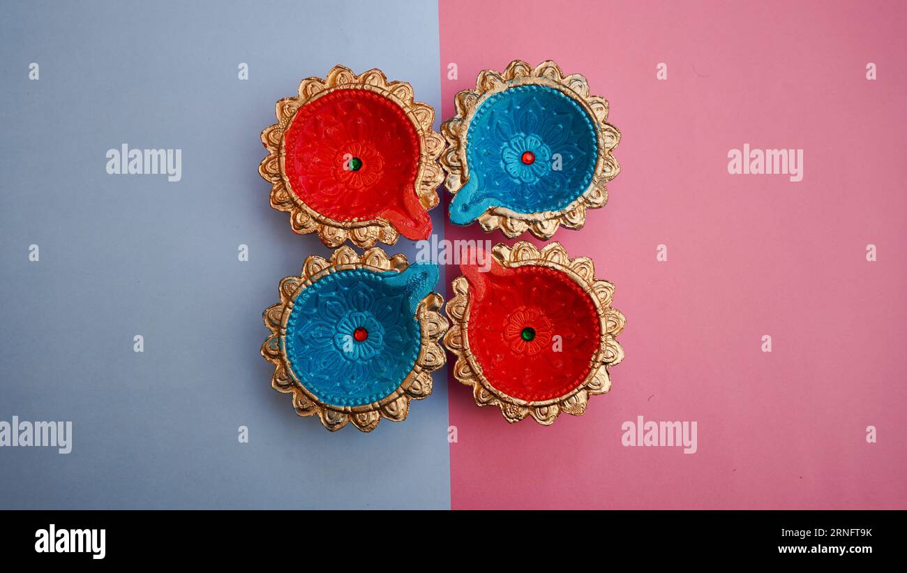 colorful diya for diwali celebration. hindu religious people light up ...