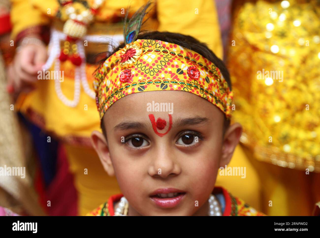 A boy dressed as Hindu Lord Krishna takes part in a celebration of ...