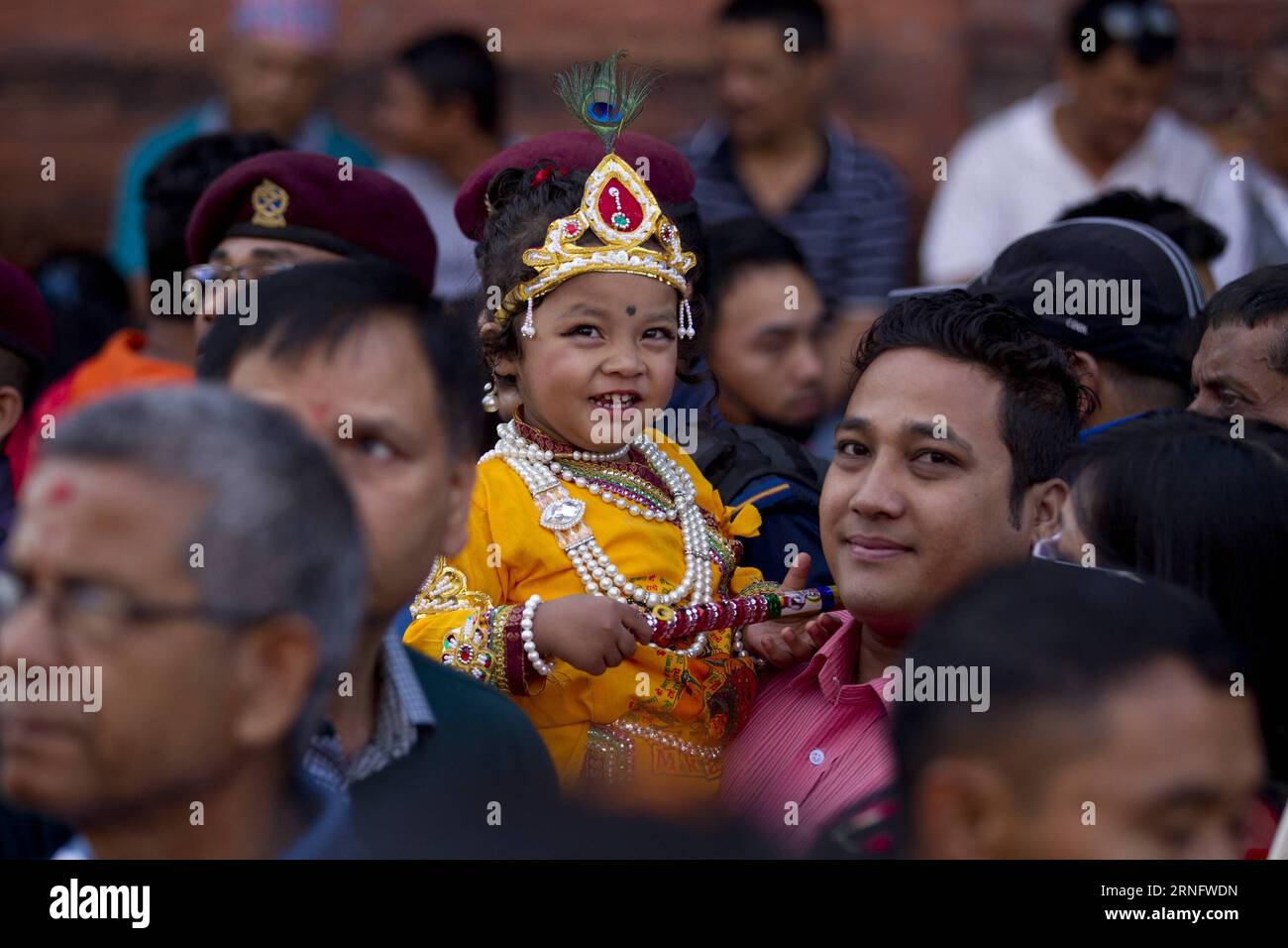 A boy dressed as Hindu Lord Krishna takes part in a celebration of ...
