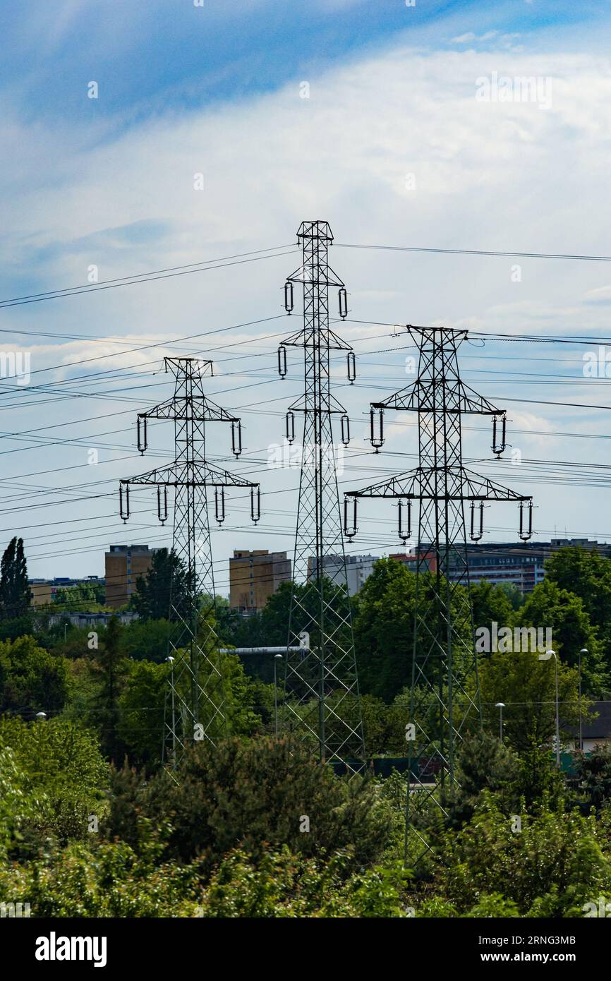 Beautiful cityscape at cloudy day with tree energy towers and a lot of ...