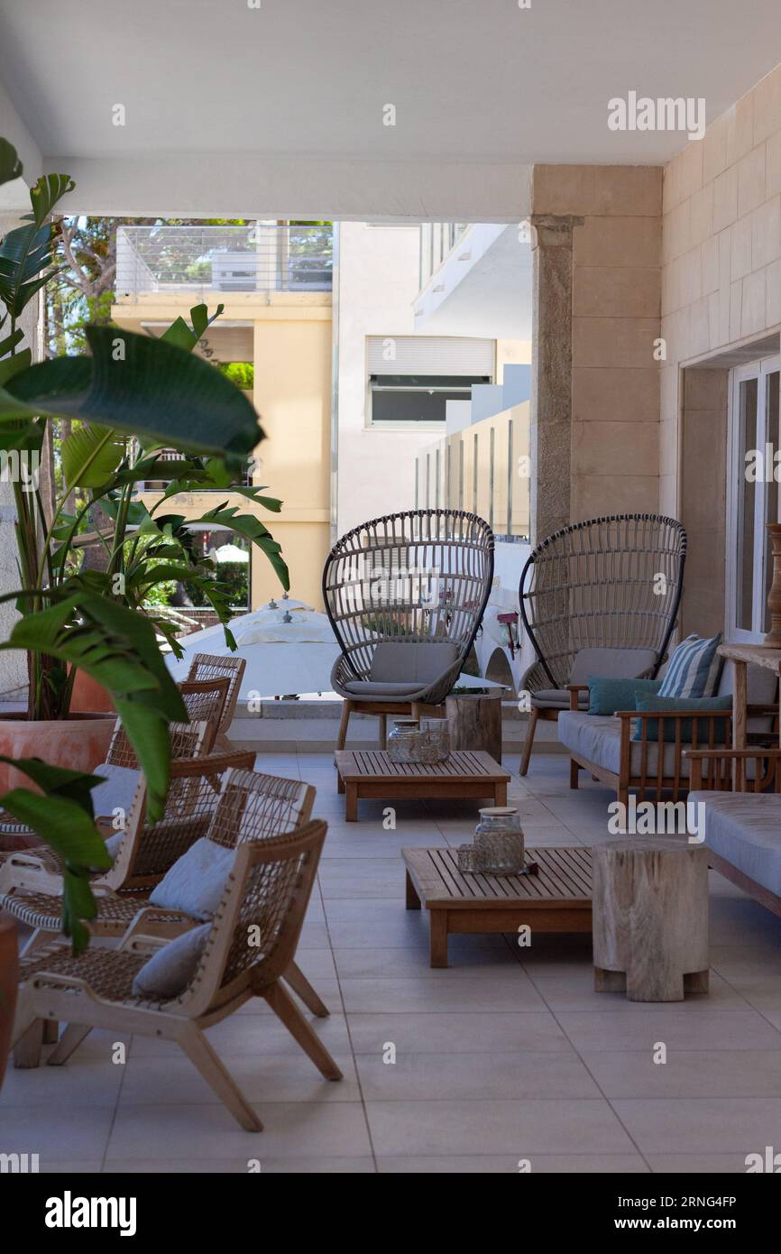 Wooden sofa and coffee tables on cozy stylish modern terrace, patio at ...