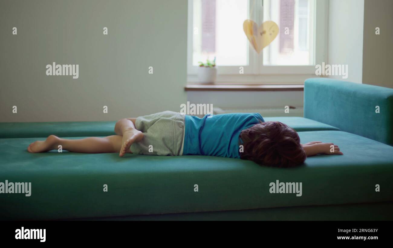 Bored child lying on couch with nothing to do, restless little boy ...