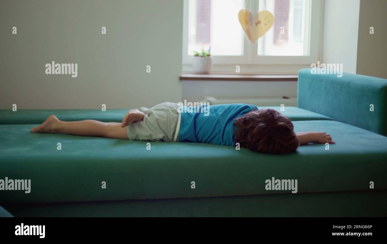 Bored child lying on couch with nothing to do, restless little boy ...