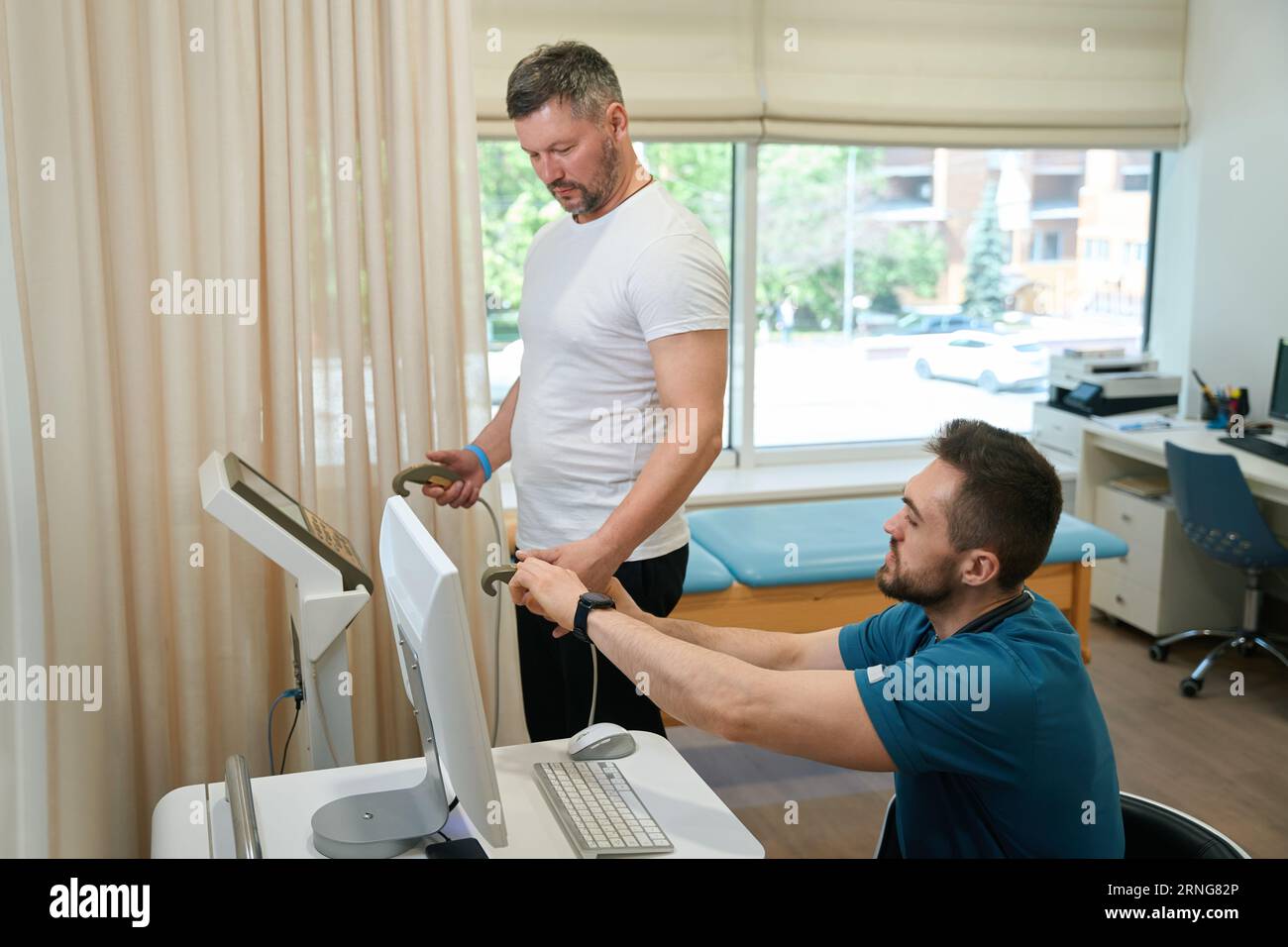 Patient being examined on BCA machine in clinic Stock Photo - Alamy