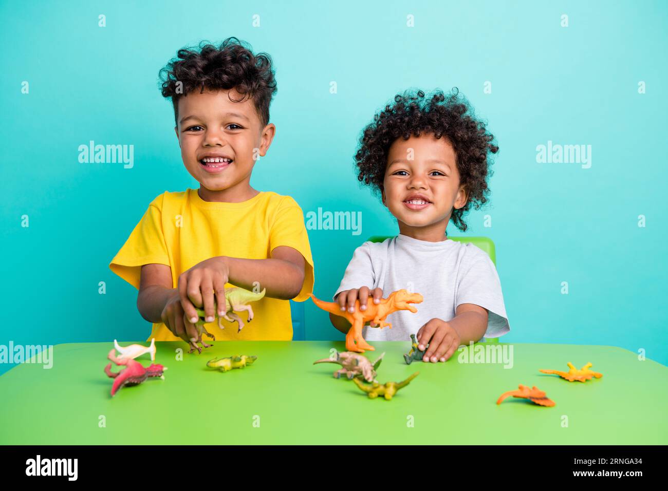 Full body photo of cute two little boys best friends sitting table ...