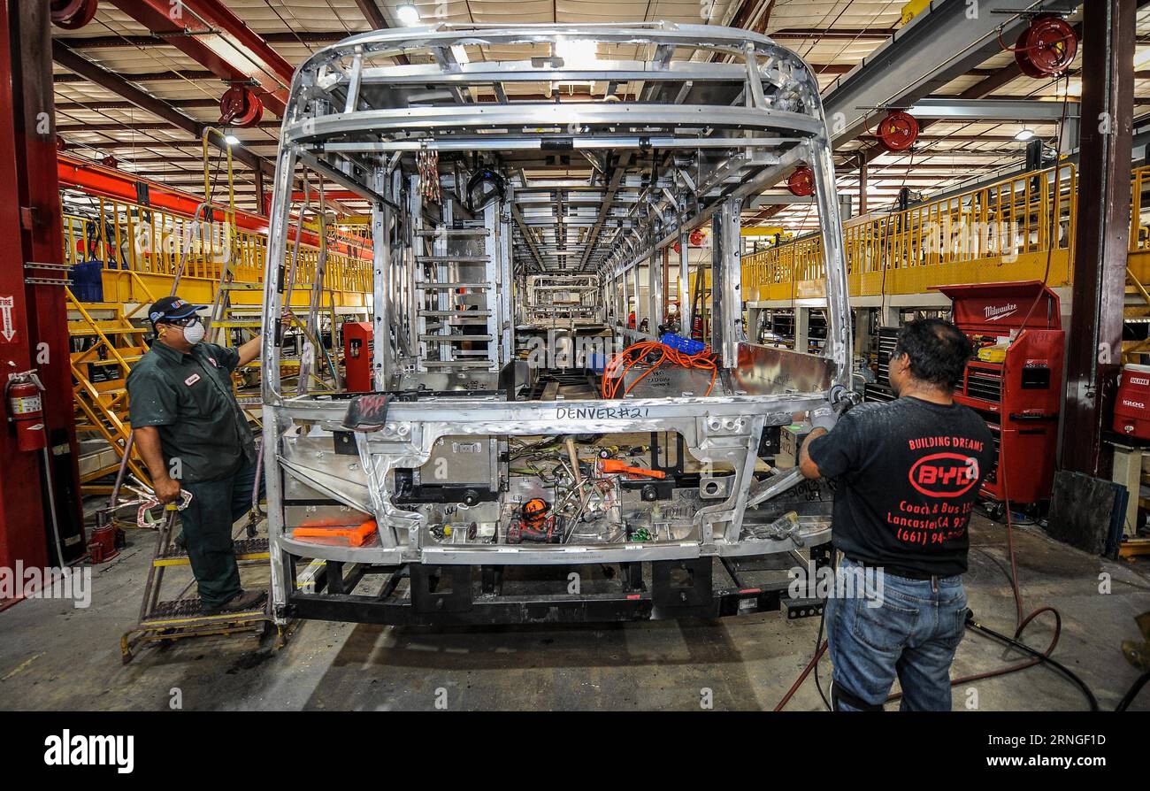 (160925) -- LANCASTER, Sept. 25, 2016 -- People work at a BYD electric ...