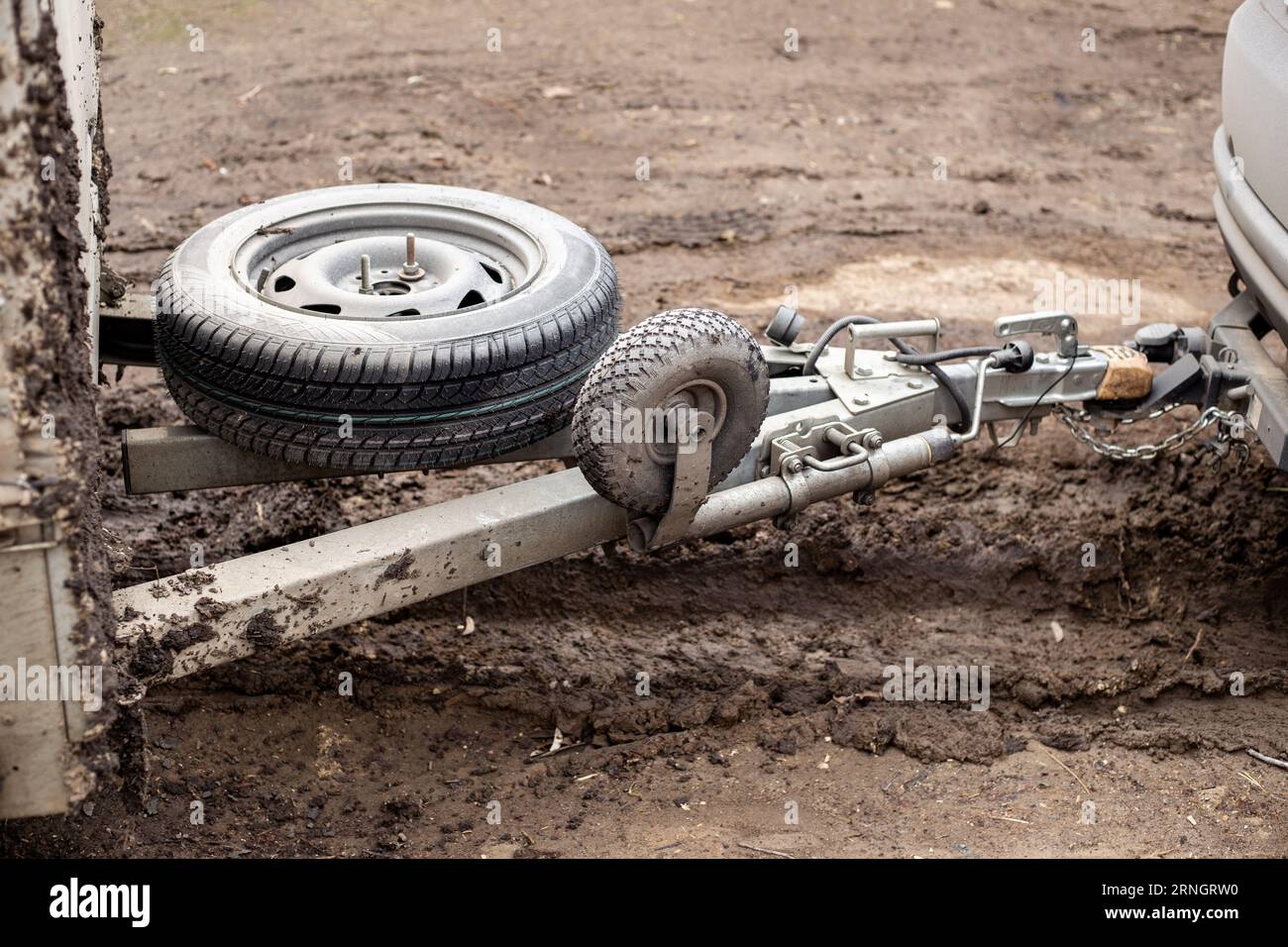 A tow hitch with a spare wheel on a trailer drawbar with a support ...