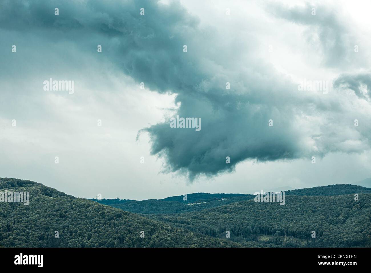 Thick funky storm clouds above slovenia in a round shape with contrast ...