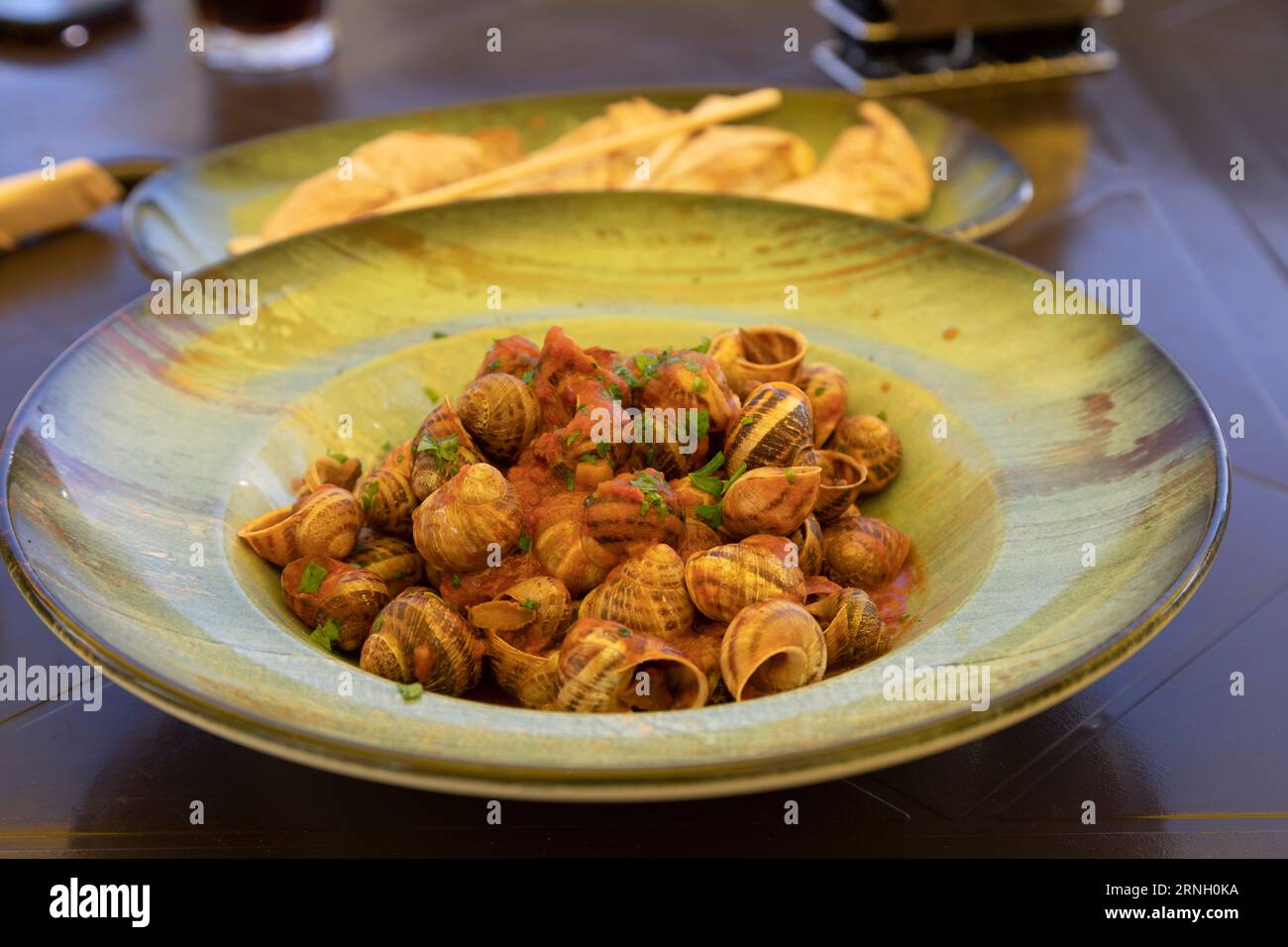 Snails in a garlicky tomato sauce served for lunch in Malta. The dish ...