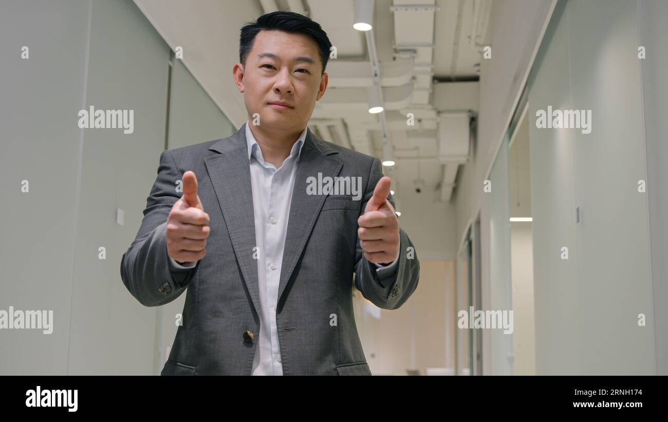Portrait satisfied Asian businessman in modern office mature middle ...