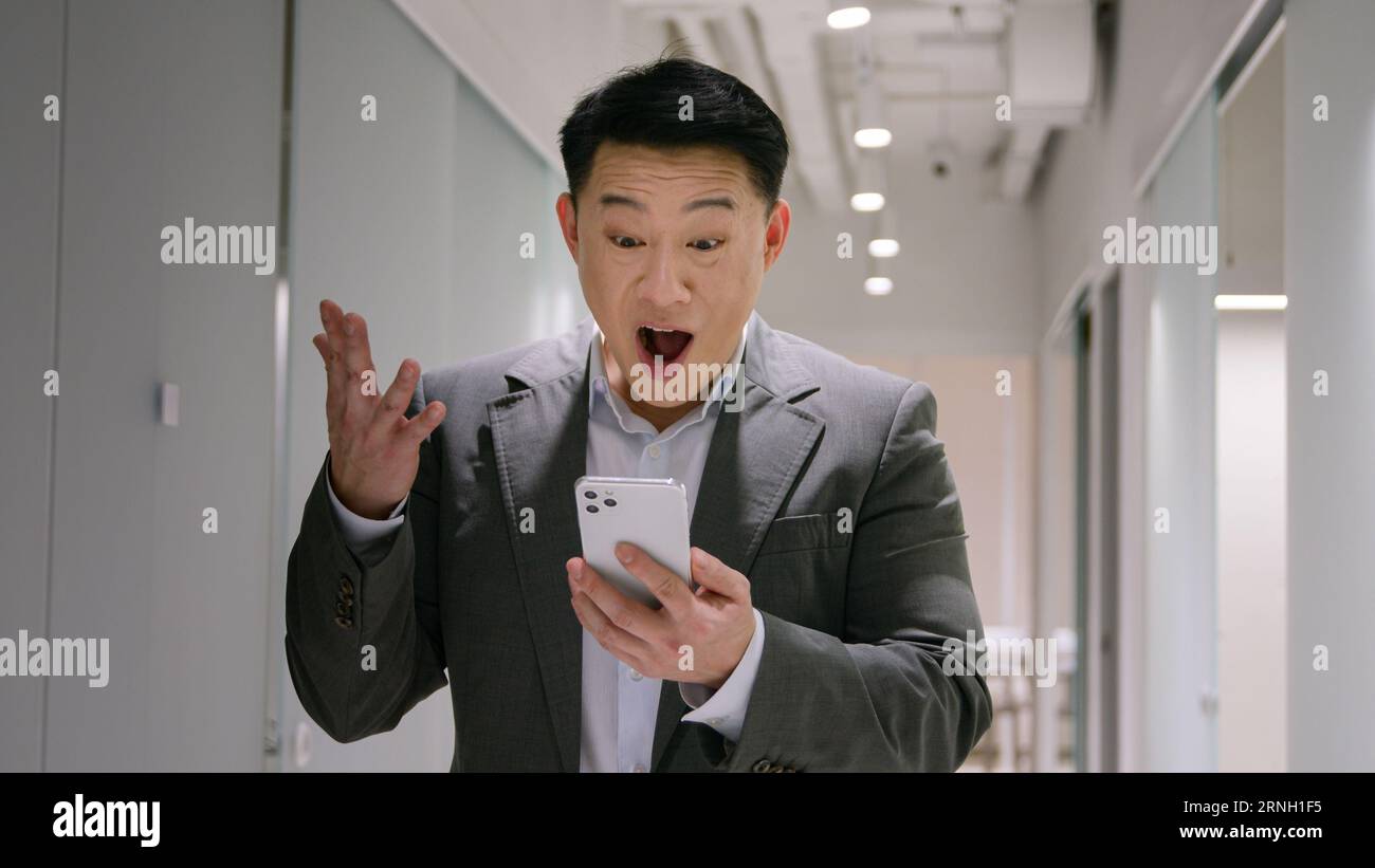 Happy surprised Asian mature man emotional winner male chinese korean ...