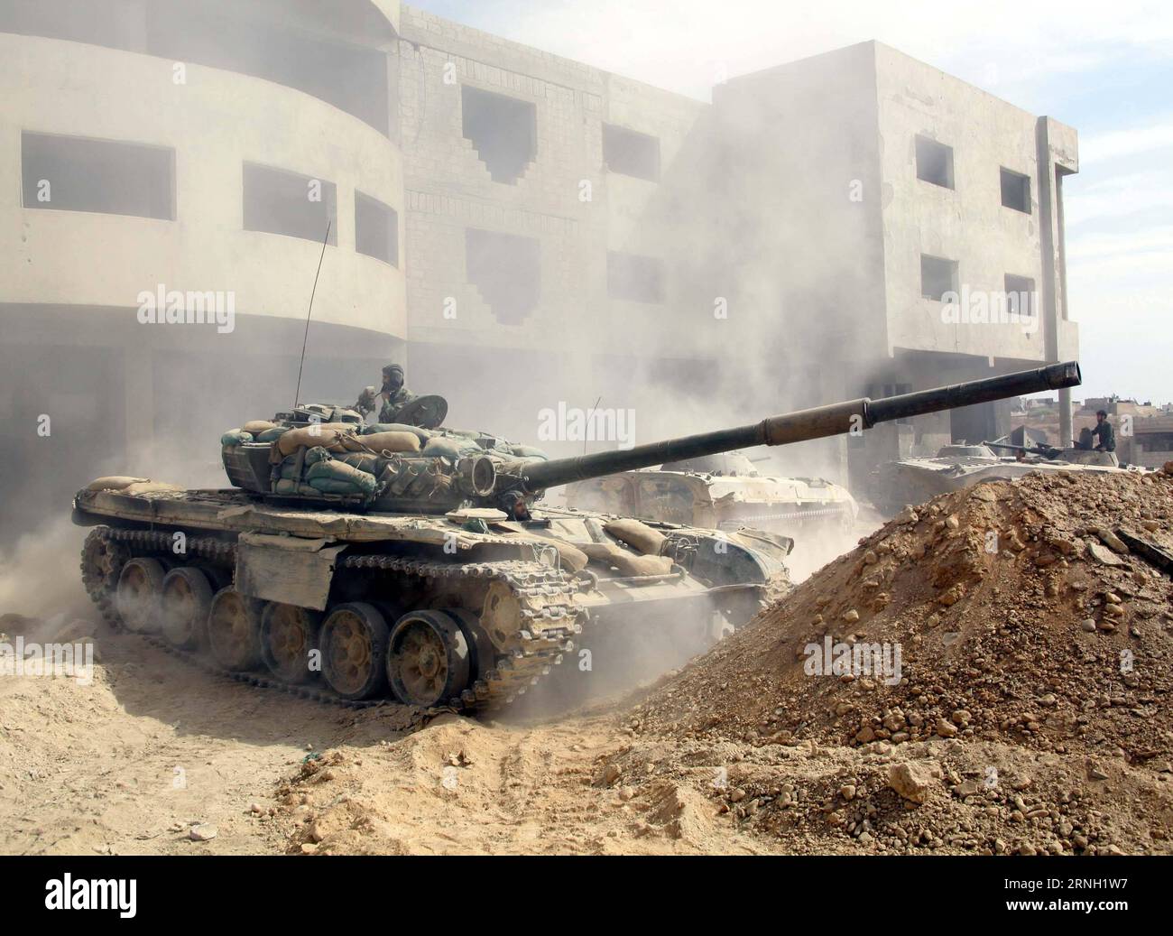A Syrian tank fires at rebel positions in the Jobar area, east of ...