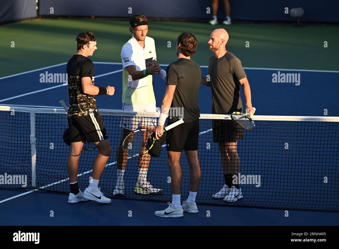 Adrian Mannarino and Arthur Rinderknech shake hands with Eliot ...