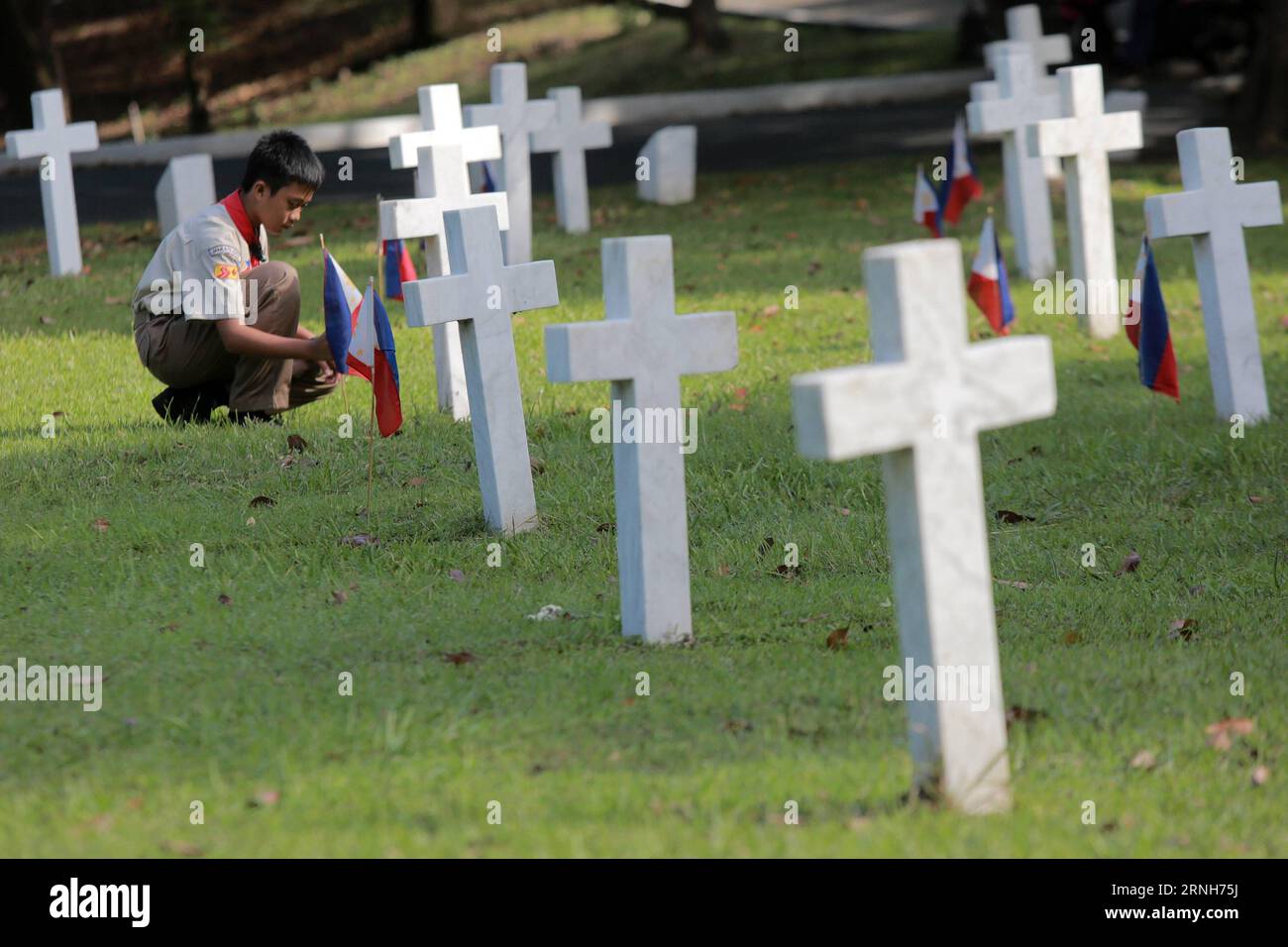 (161031) -- MANILA, Oct. 31, 2016 -- A boy places a Philippine flag on ...