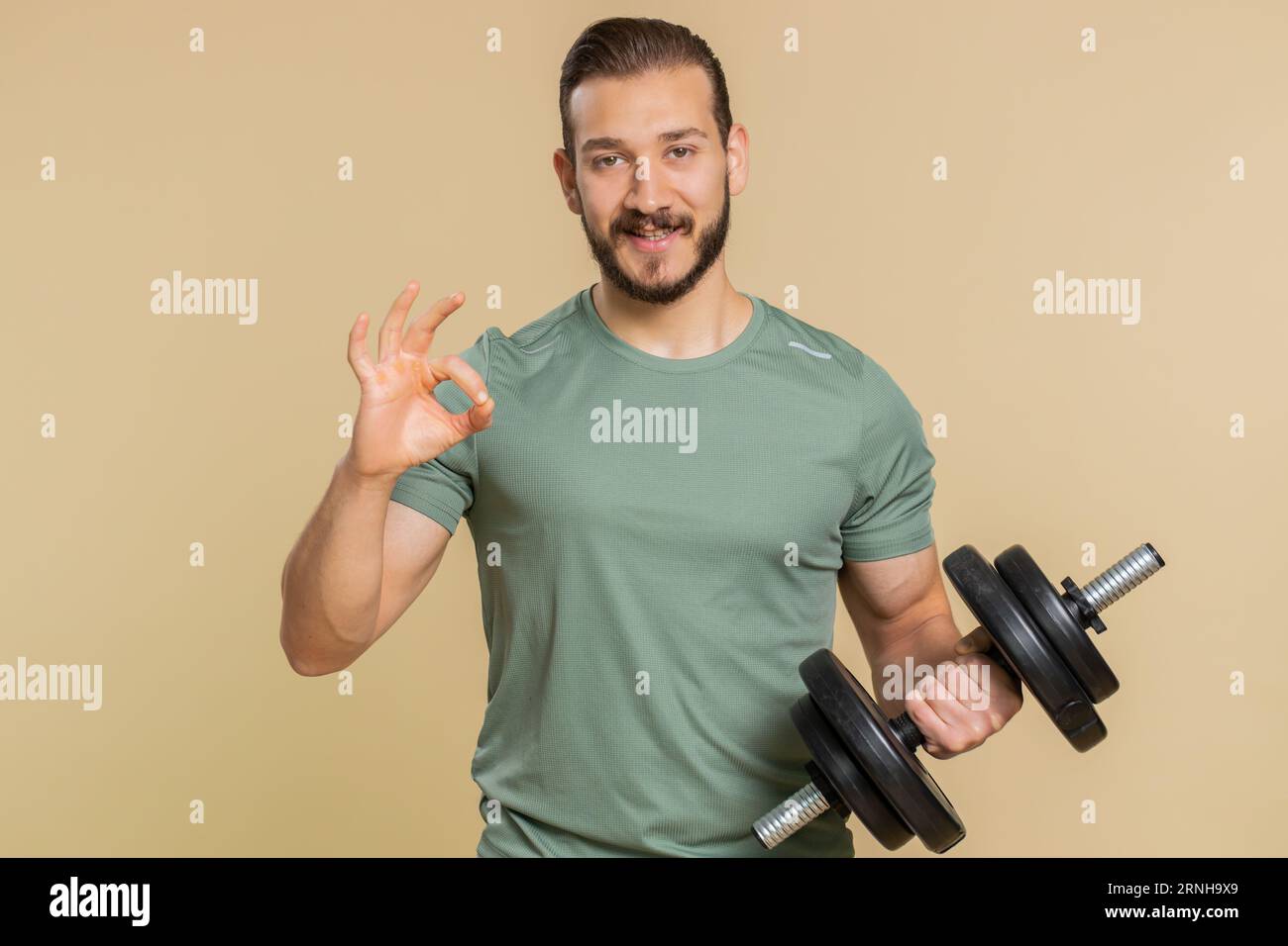 Okay. Athlete sportive man looking at camera showing ok gesture, like ...