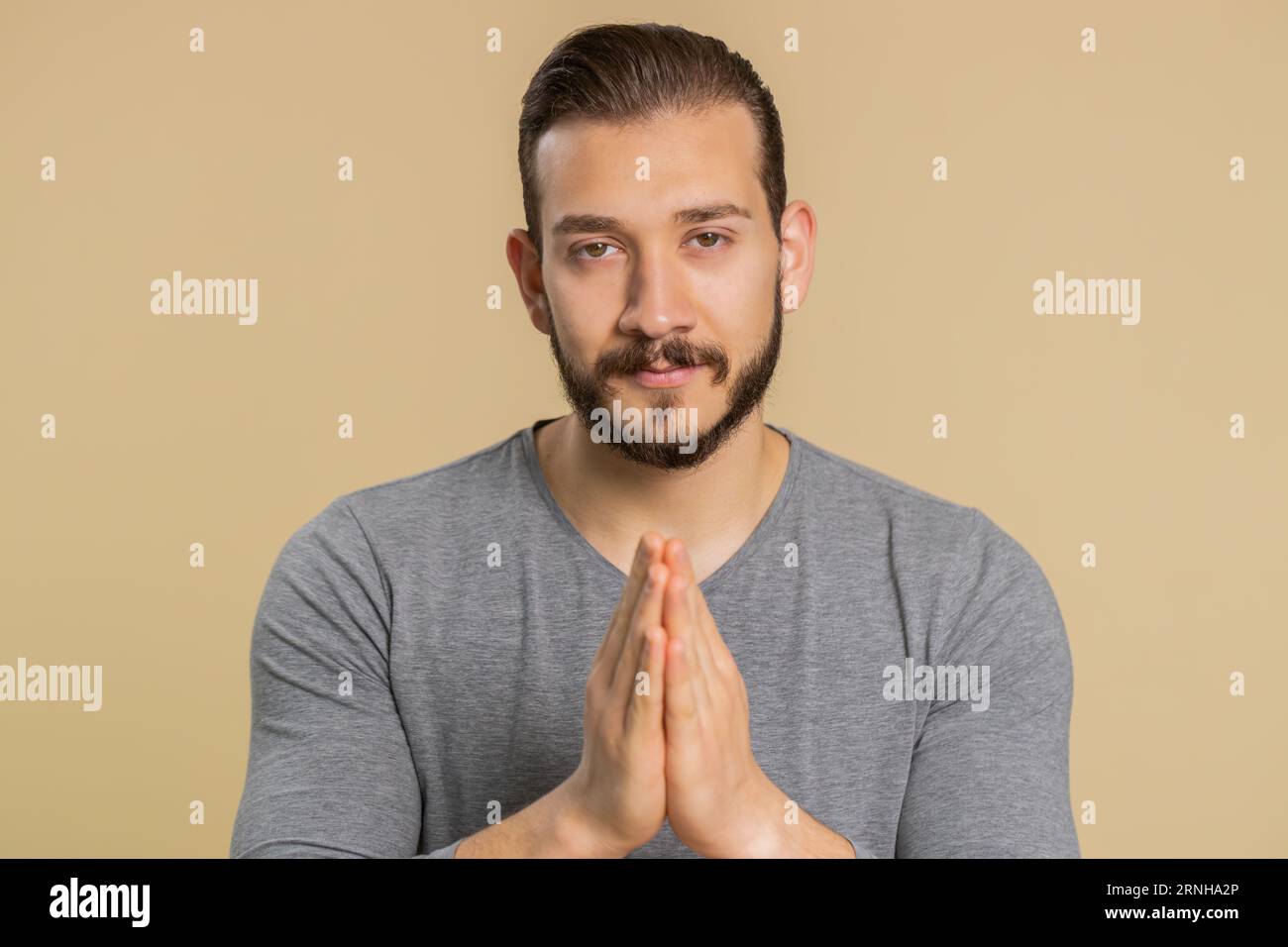 Please, God help. Lebanese young man praying, looking upward and making ...