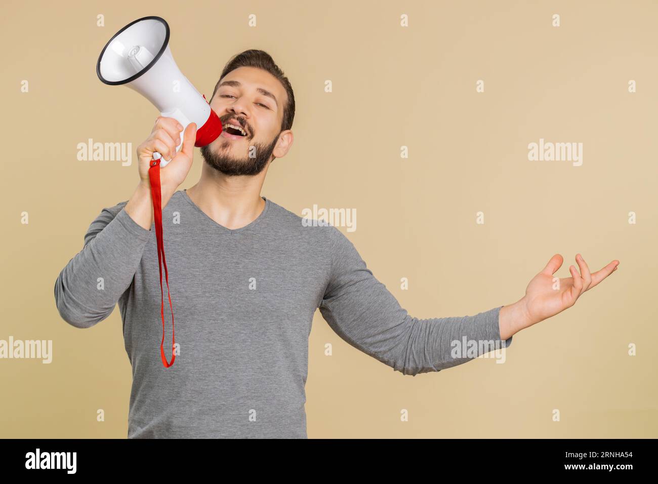 Lebanese young man talking with megaphone, proclaiming news, loudly ...