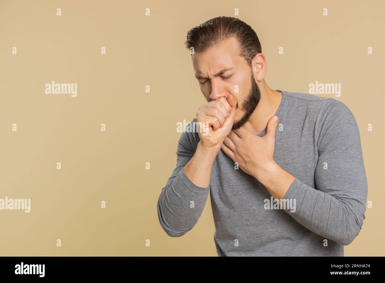 Unhealthy lebanese young man coughing covering mouth with hand feeling ...