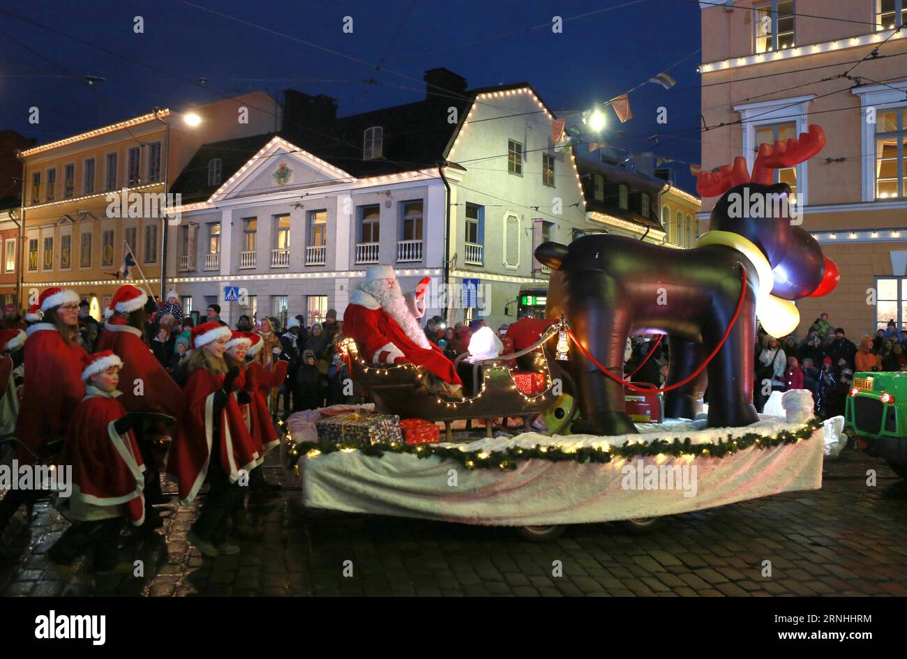 Santa Claus rides a reindeer float in a parade in central Helsinki ...