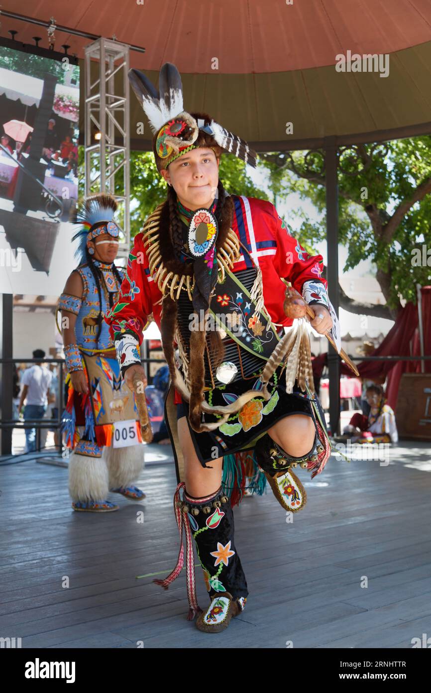 A young girl from a Native American tribe competes for best regalia at ...
