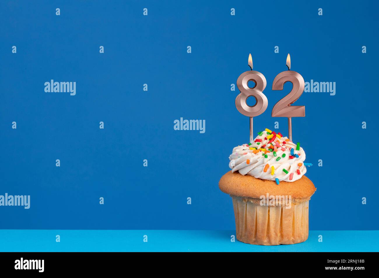 Birthday cupcake on blue background - pink birthday candle number Stock ...