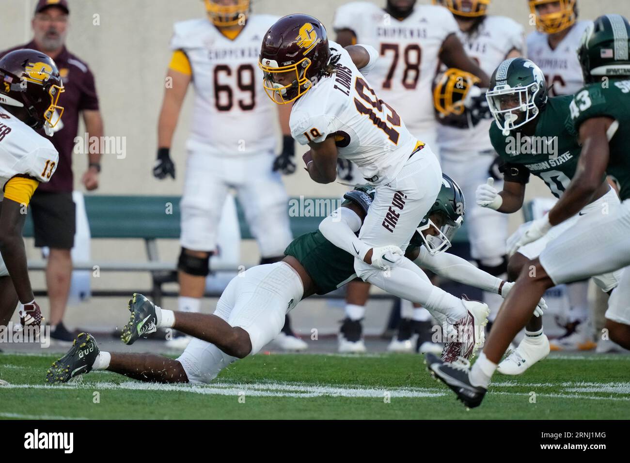Central Michigan wide receiver Tyson Davis is tackled by Michigan State ...