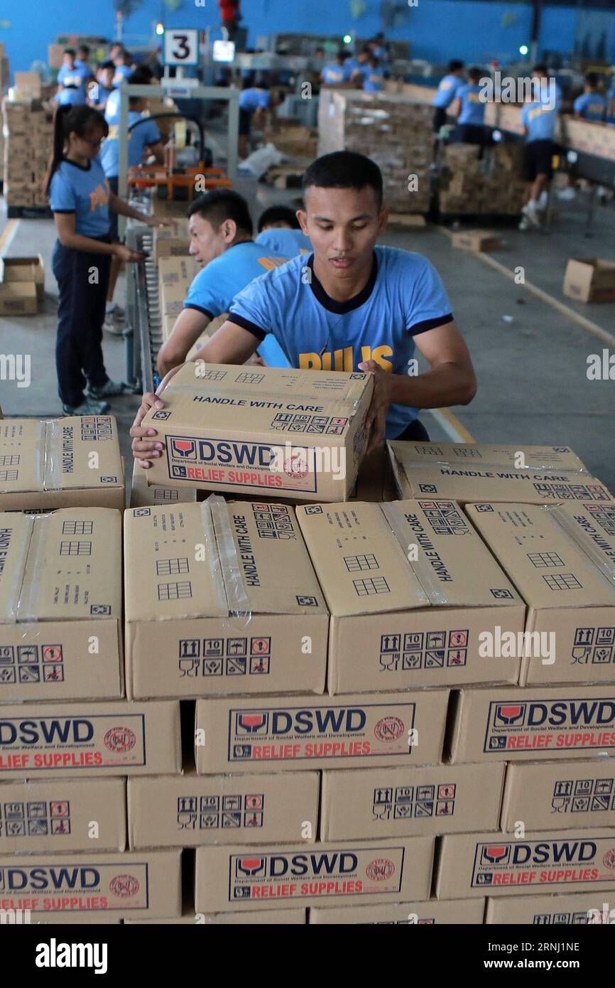 Personnel from the Philippine National Police (PNP) pack boxes with ...