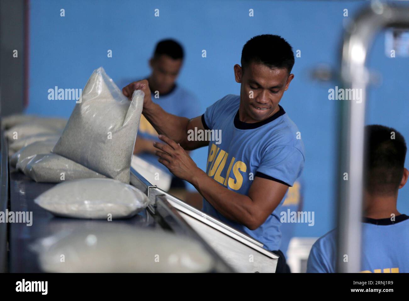 Personnel from the Philippine National Police (PNP) pack boxes with ...
