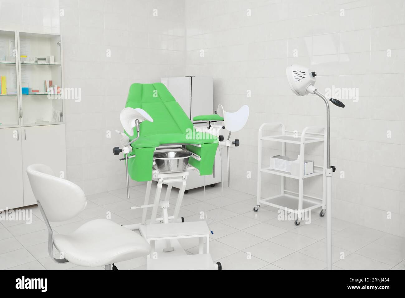 Modern gynecological office interior with examination chair and medical ...