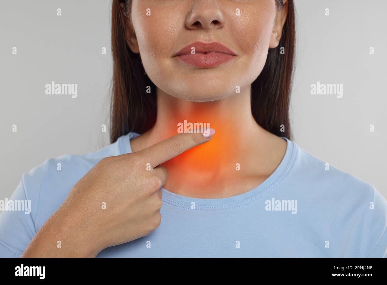 Endocrine system. Woman doing thyroid self examination on light grey ...