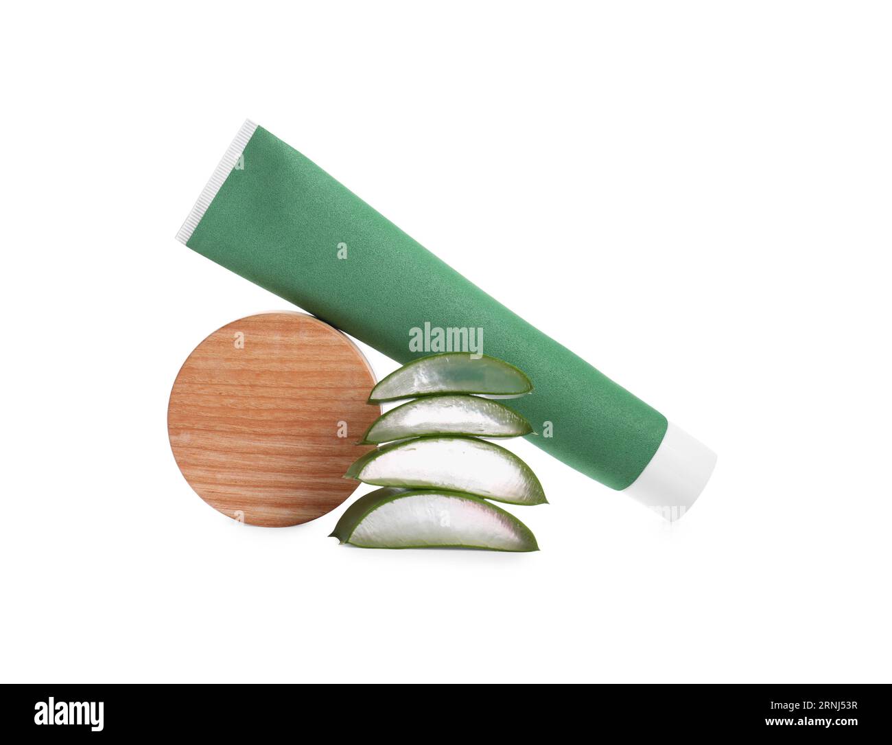 Tube of toothpaste, cut aloe vera and wooden decor on white background ...