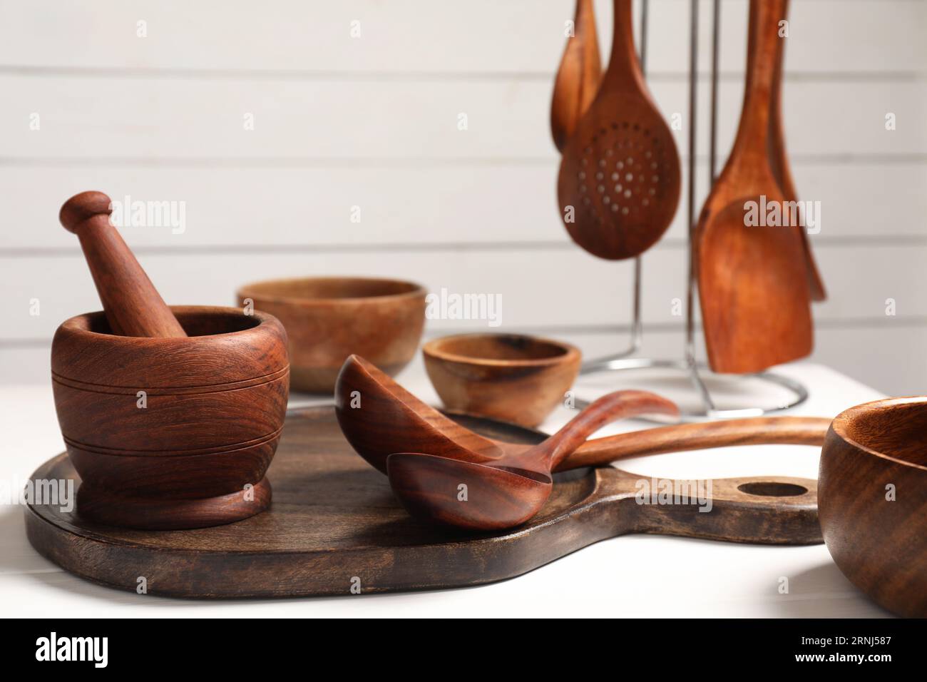 Set of different kitchen utensils on white table Stock Photo - Alamy