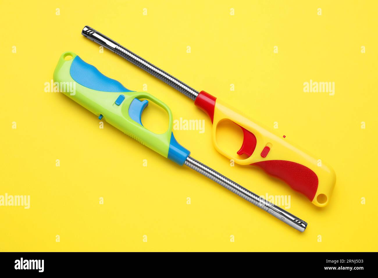Gas lighters on yellow background, flat lay Stock Photo - Alamy