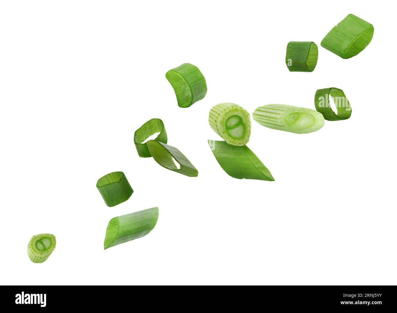 Cut green onion falling on white background Stock Photo - Alamy