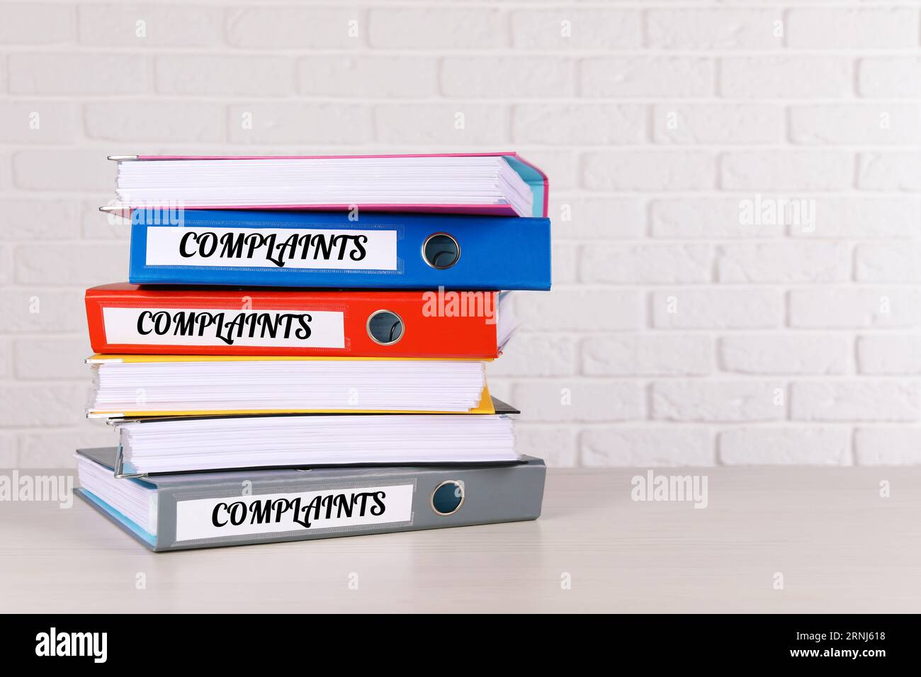 Colorful folders with Complaints labels on table, space for text Stock ...