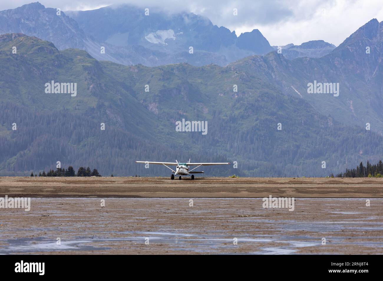 Small airplane in wilderness landed by bush pilot on gravel beach ...
