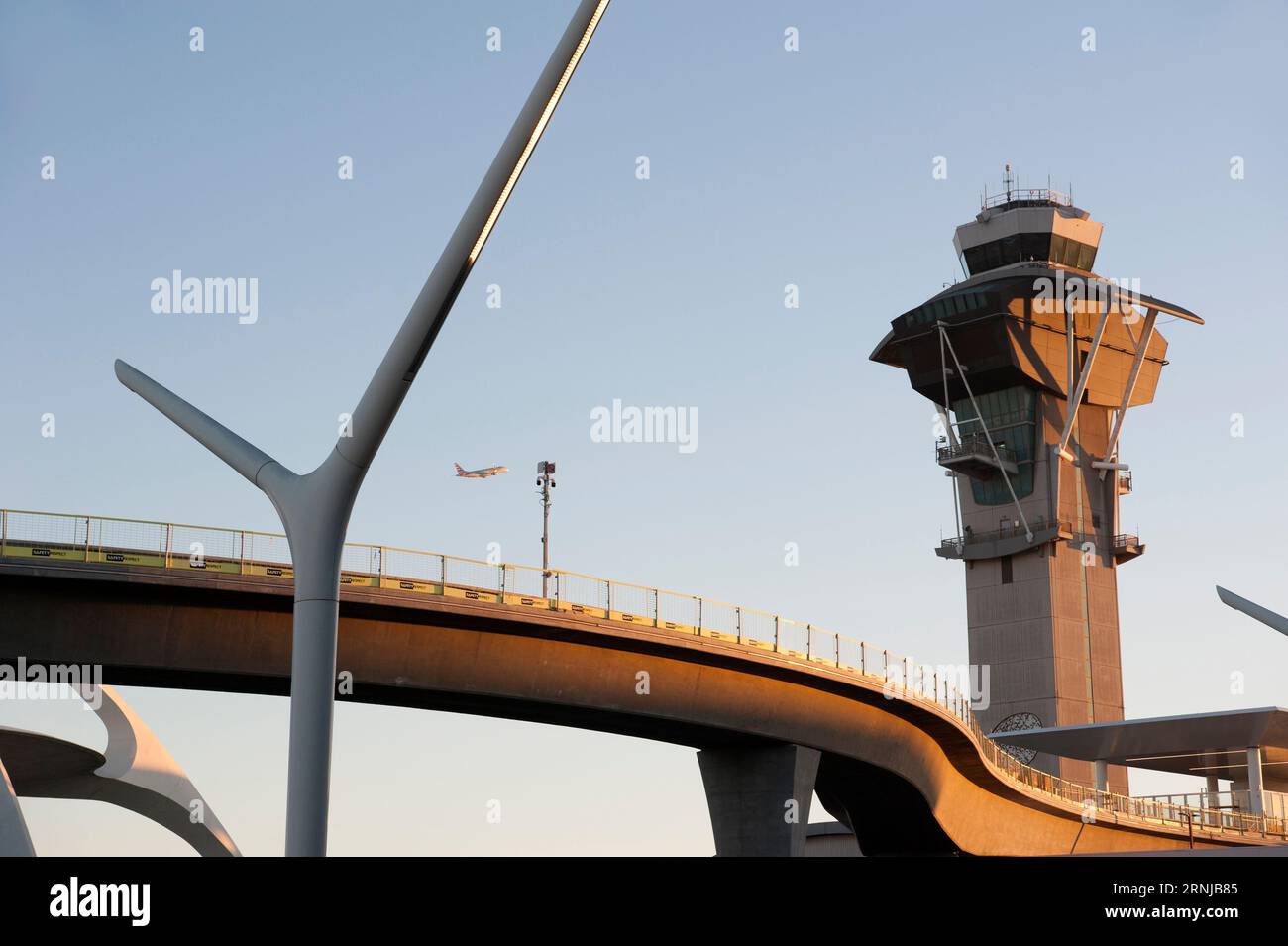 A plane departing from LAX flies over newly installed tracks for the ...