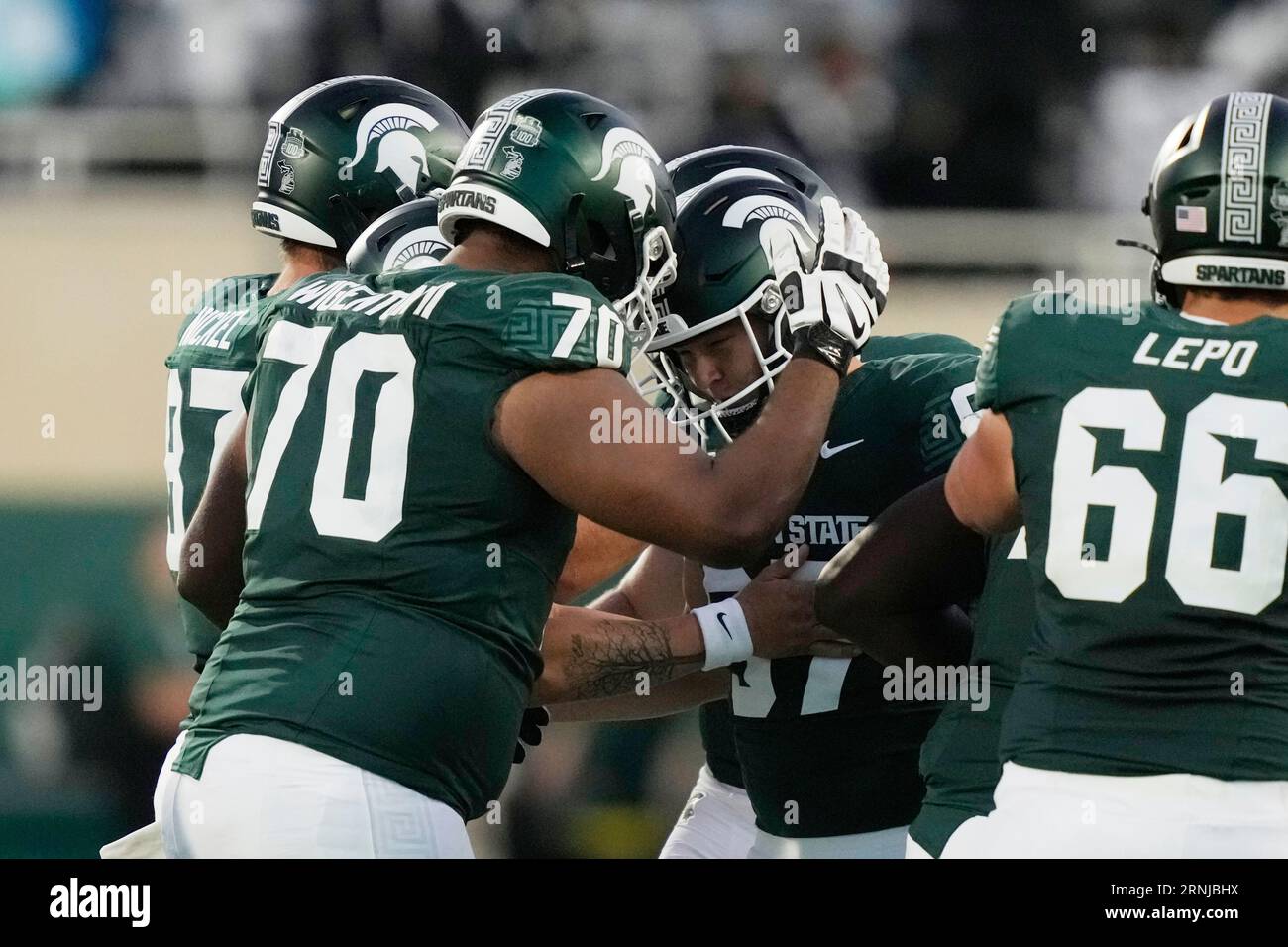 Michigan State offensive lineman Kevin Wigenton II (70) congratulates ...