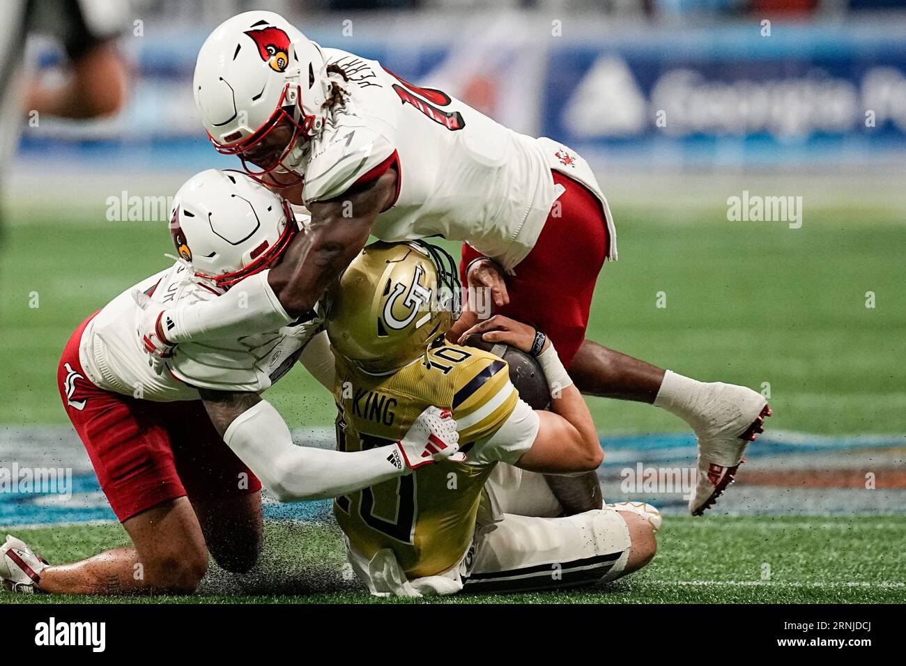 Georgia Tech quarterback Haynes King (10) is hiot by Louisville ...